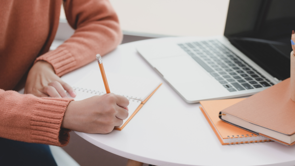 Student Writing on Paper - Graduate Students' Association